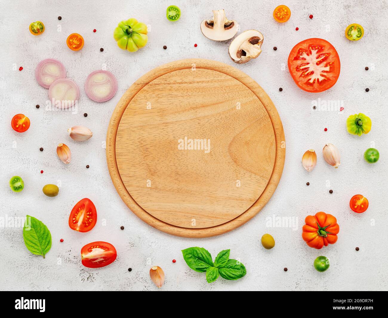 The ingredients for homemade pizza set up on white concrete background ...