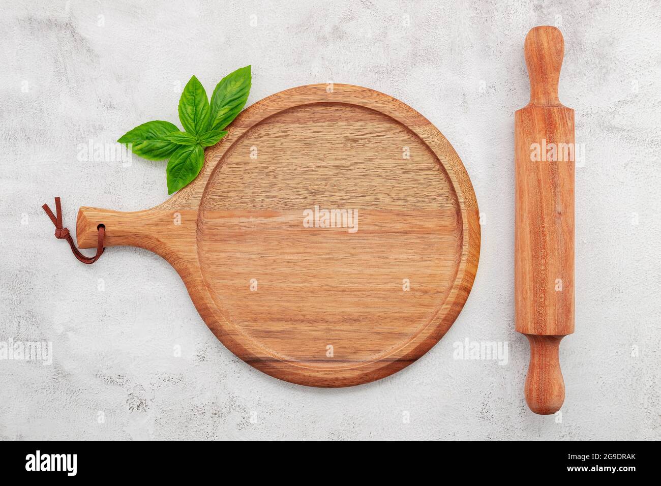 Empty wooden pizza platter set up on white concrete. Pizza tray on ...