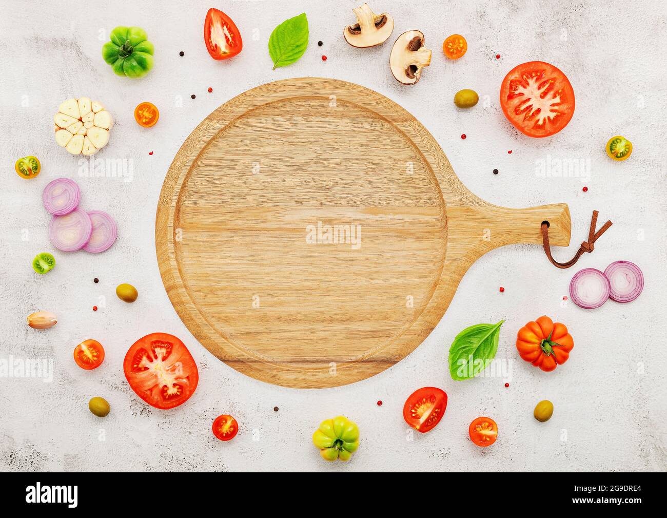 The ingredients for homemade pizza set up on white concrete background ...