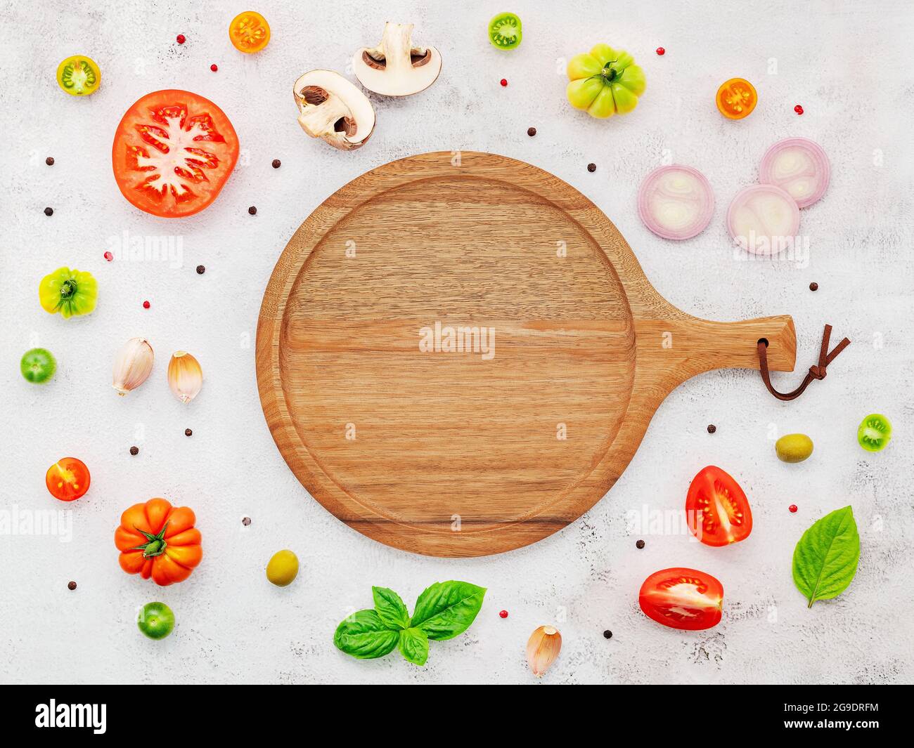 The ingredients for homemade pizza set up on white concrete background ...