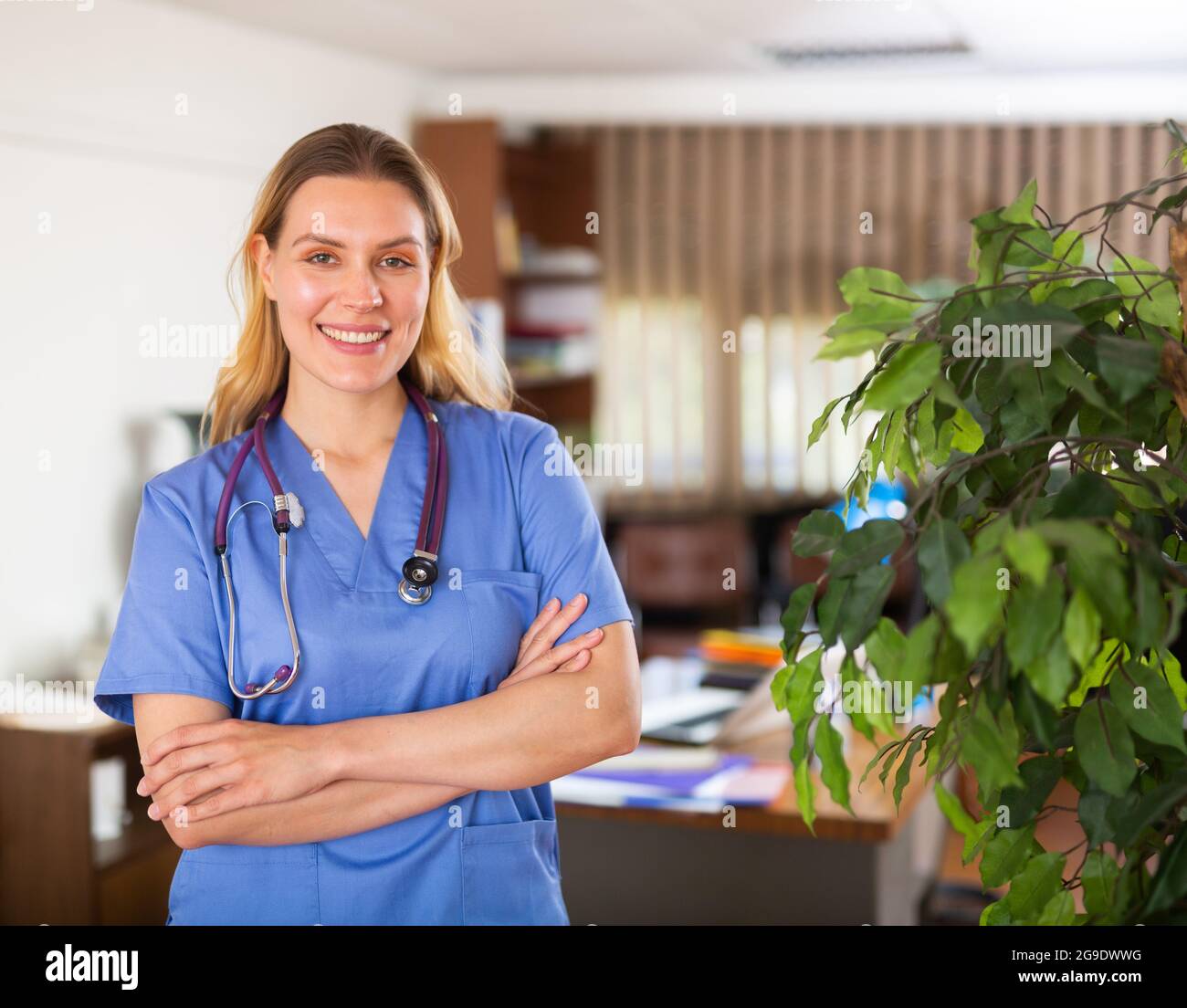 Positive female doctor posing in private clinic Stock Photo - Alamy