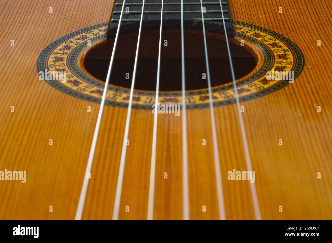 Closeup of the strings of a brown acoustic guitar Stock Photo - Alamy