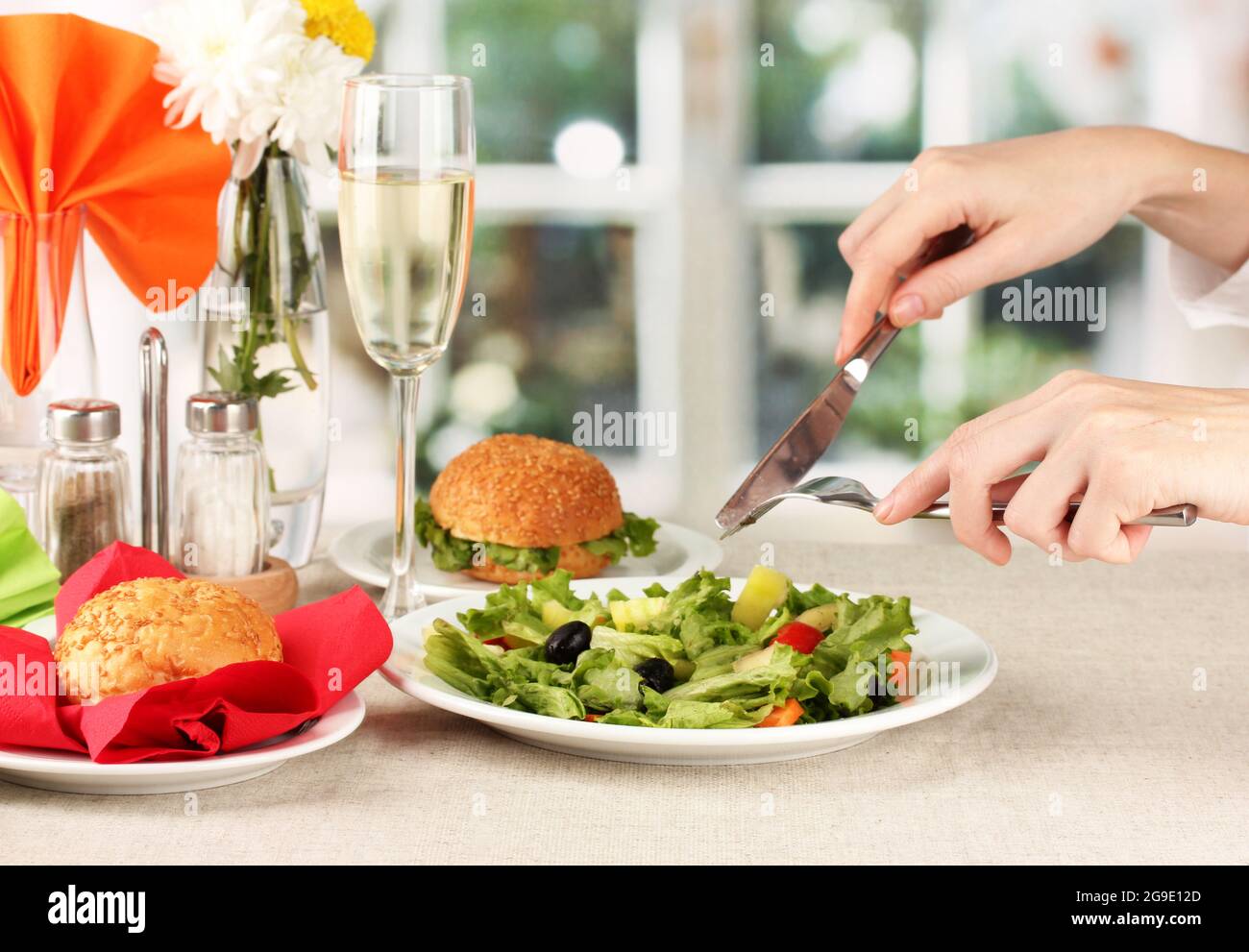 Female hand with dinner on bright background Stock Photo - Alamy