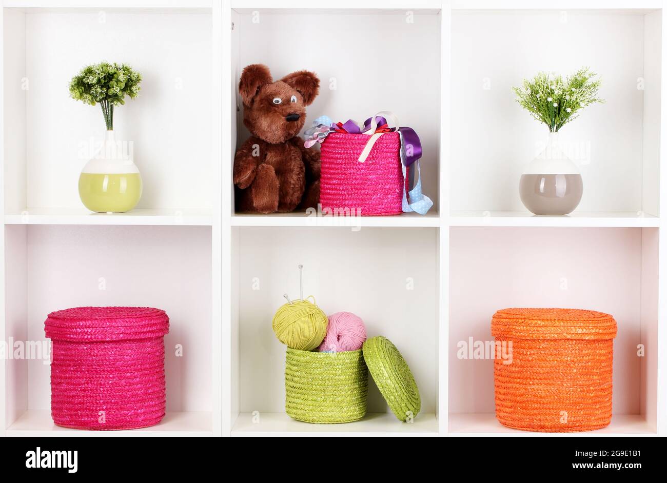 Color wicker boxes on cabinet shelves Stock Photo - Alamy