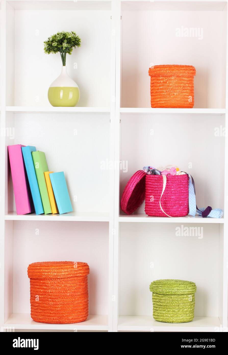 Color wicker boxes on cabinet shelves Stock Photo - Alamy