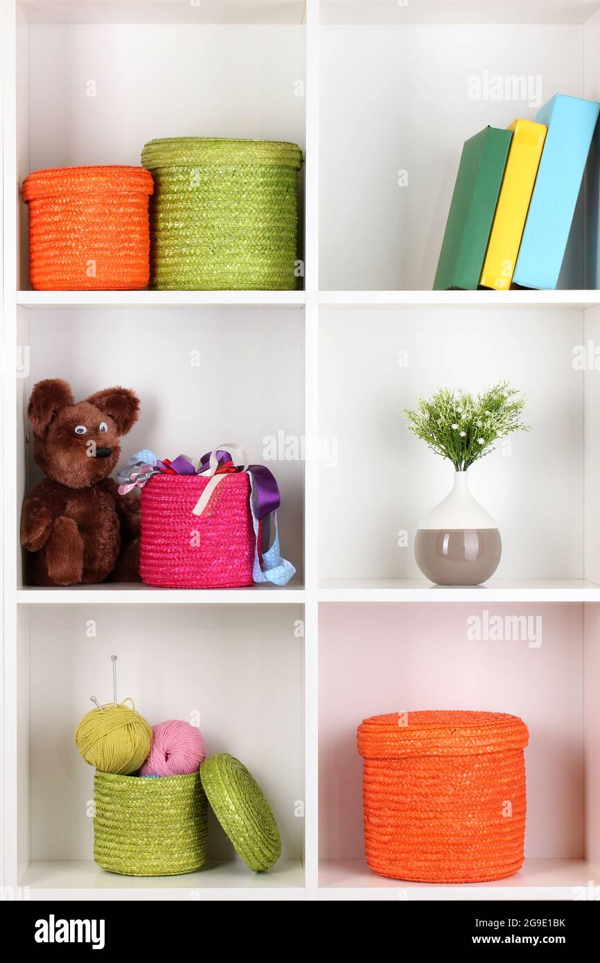 Color wicker boxes on cabinet shelves Stock Photo - Alamy