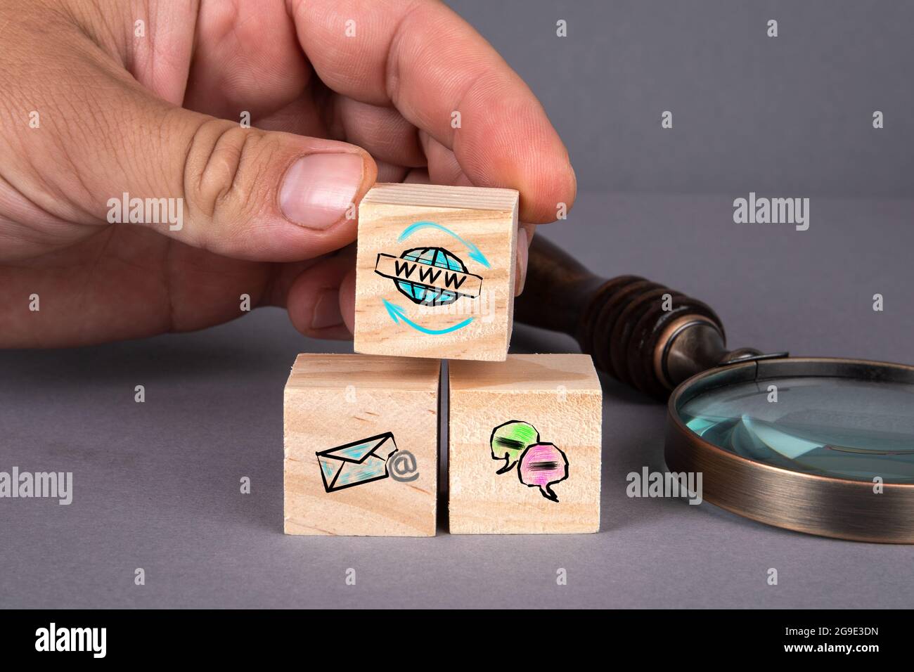 Digital Marketing concept. Magnifying glass and wooden blocks on a gray ...