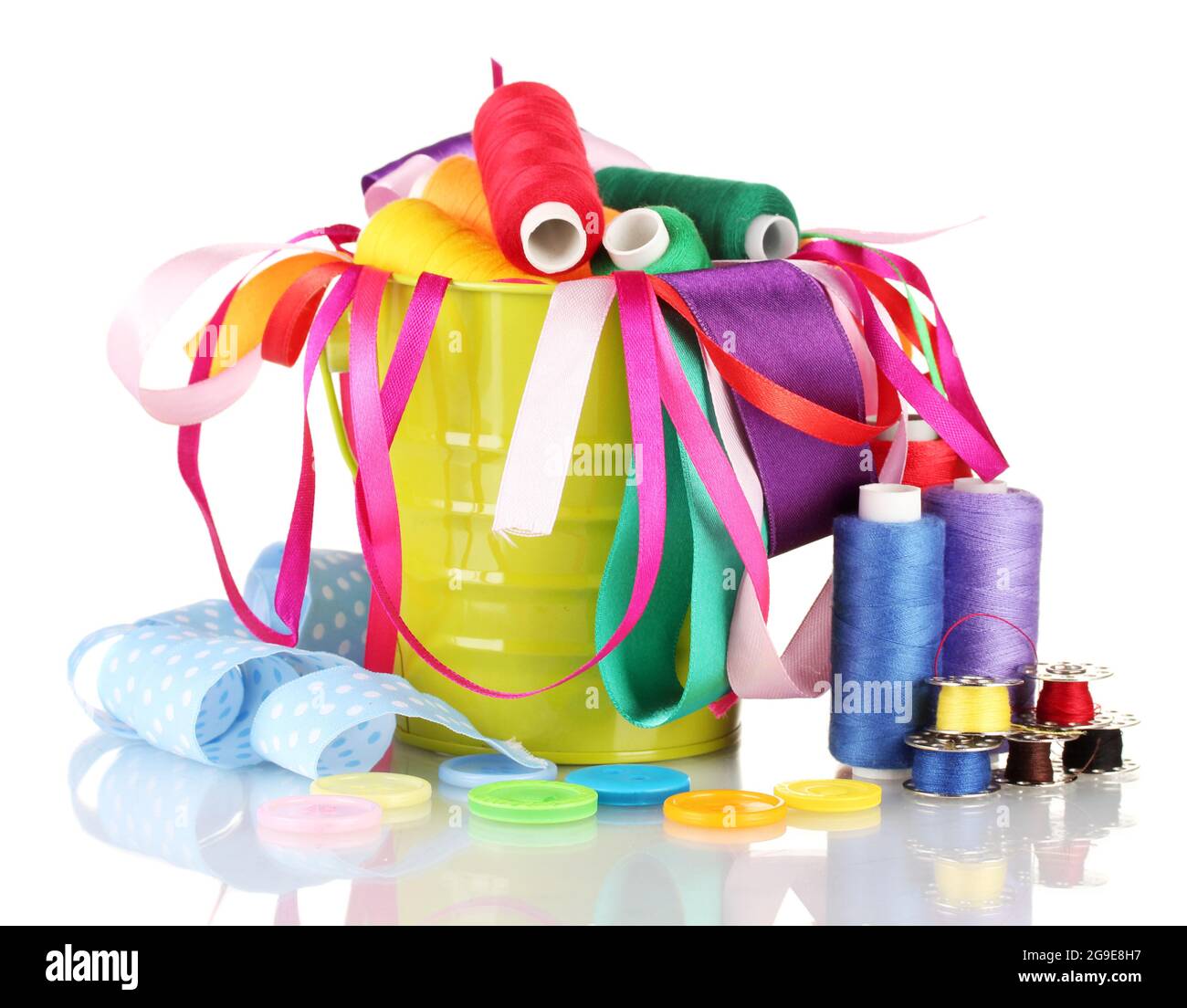 Color bucket with multicolor ribbons and thread isolated on white Stock ...