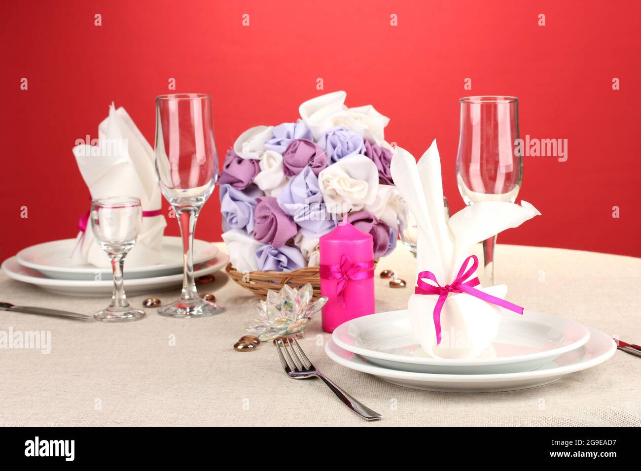 Table setting in purple tones on color background Stock Photo - Alamy
