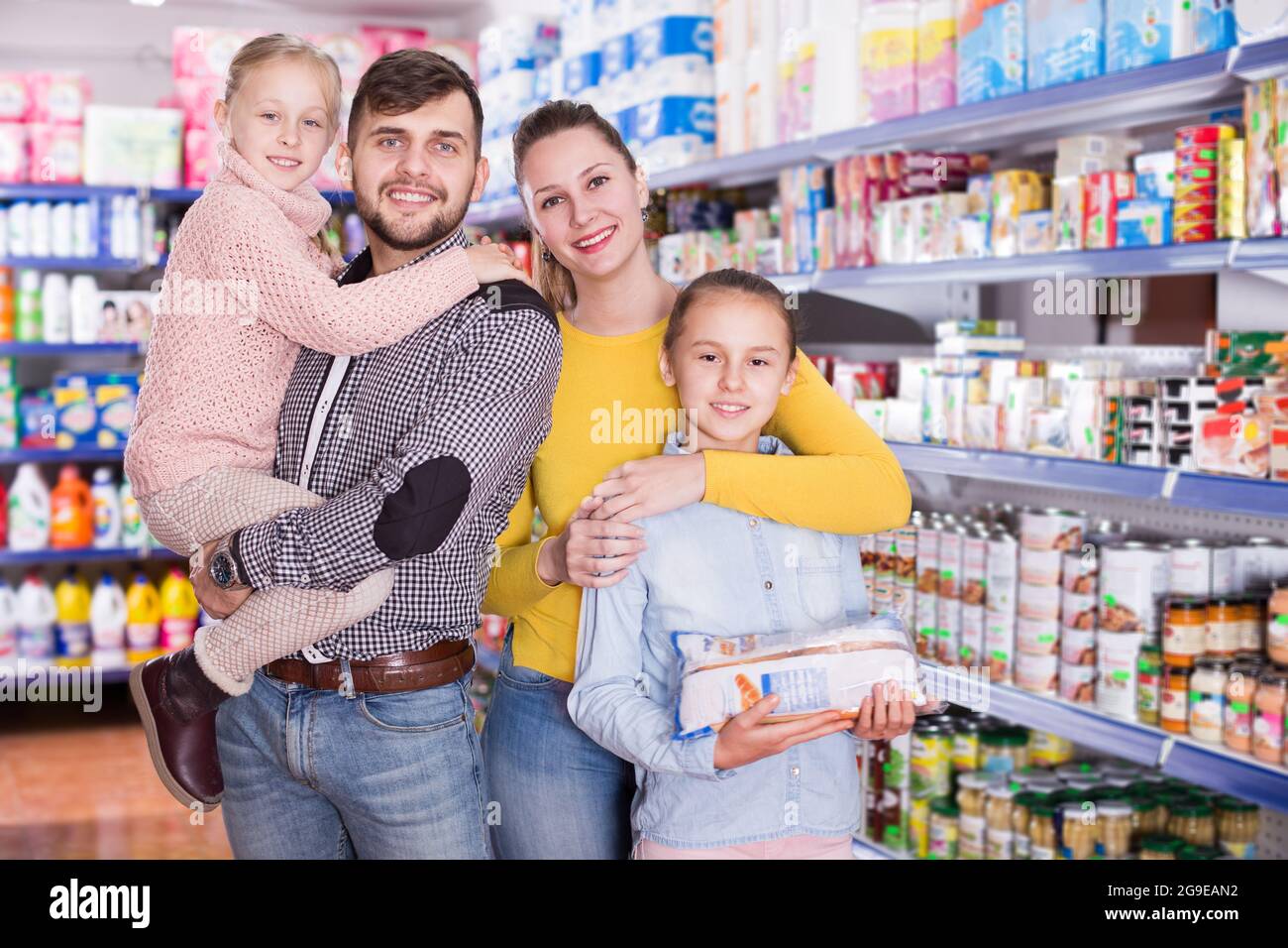 Portrait of family with daughters in food store Stock Photo - Alamy