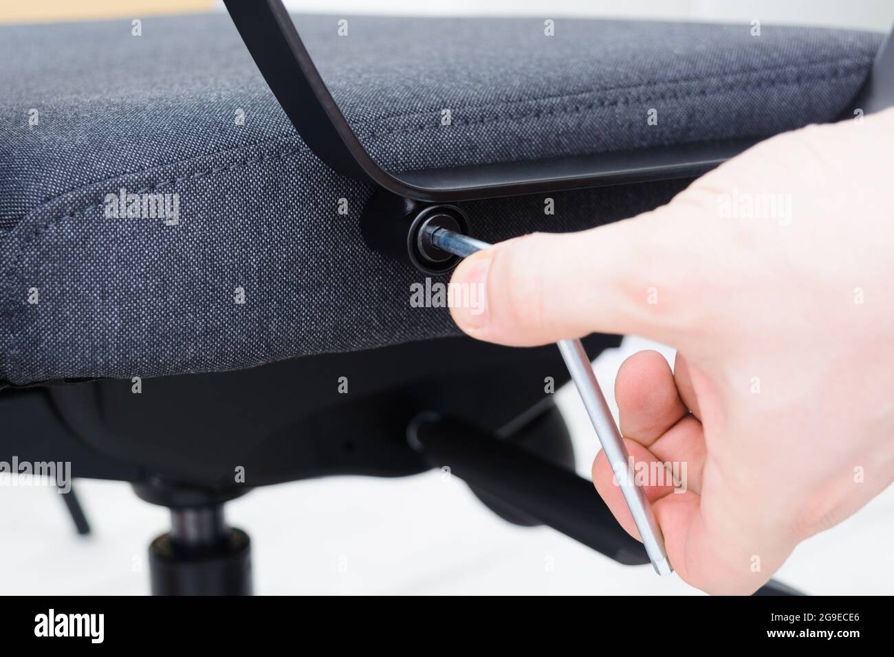 Man hands screw chair handle Assembling chair Step by step instructions ...