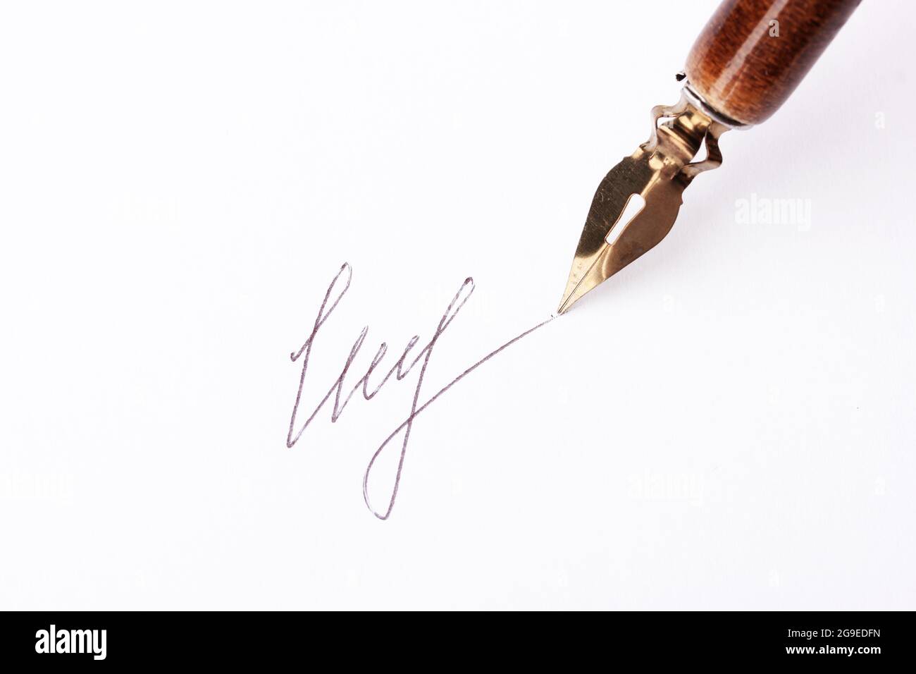 Closeup of signature (fake, not real) and ink pen, isolated on white ...