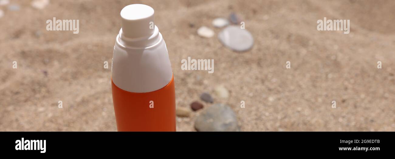 Sunscreen stands on sand next to cast of stones lined with feet Stock ...