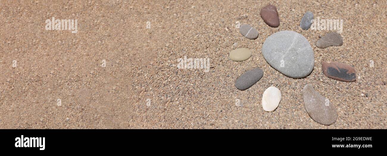 Figure of sun is made of stones on beach sand Stock Photo - Alamy
