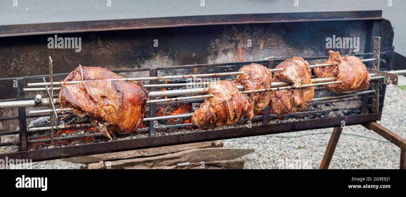 meat on the grill or spit on the street during an event Stock Photo - Alamy