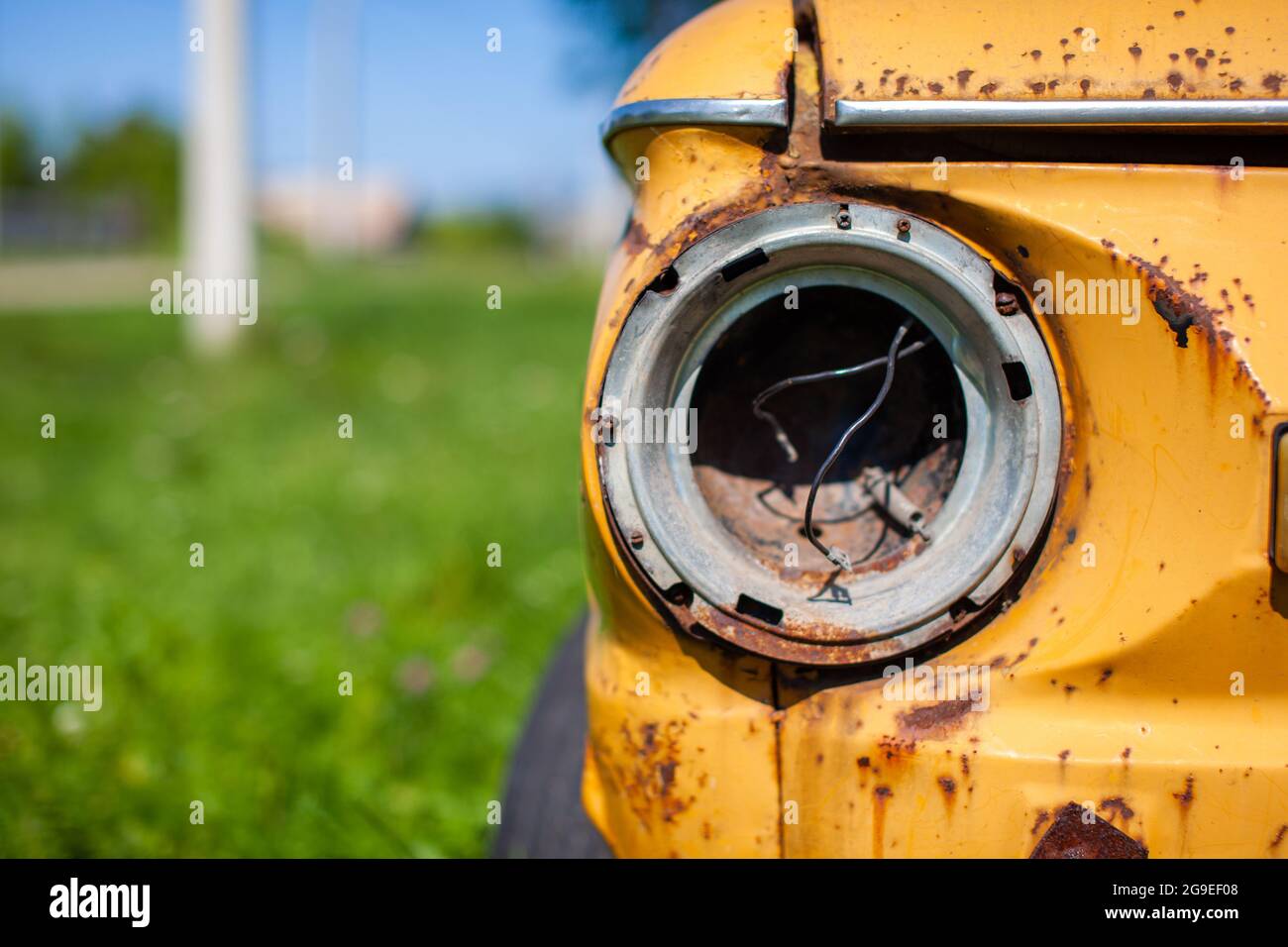 Old yellow wrecked car in vintage style. Abandoned rusty yellow car ...