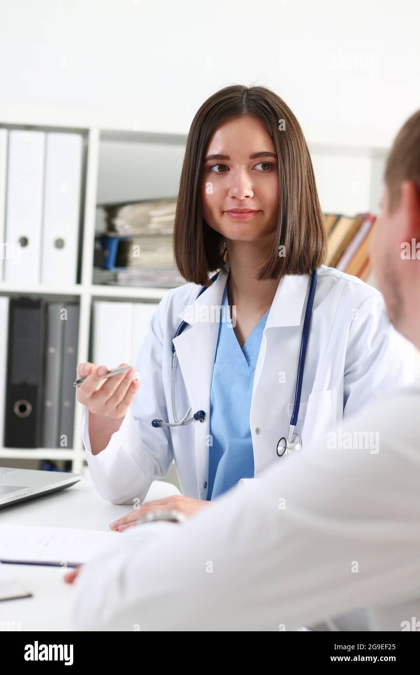 Female doctor hand hold silver pen and showing pad Stock Photo - Alamy