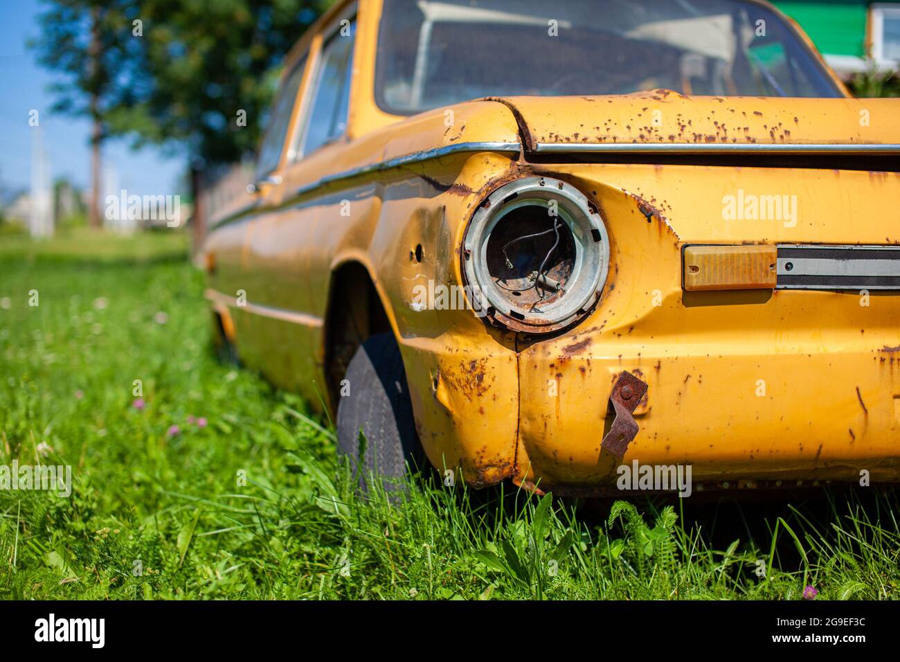 Old yellow wrecked car in vintage style. Abandoned rusty yellow car ...
