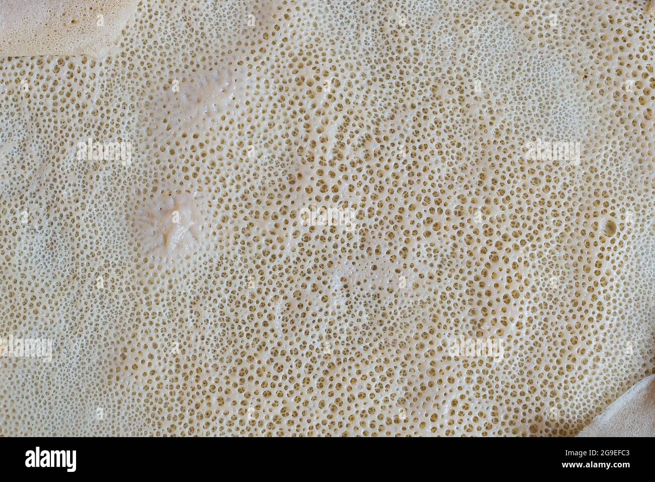 Close up of Injera, a fermented flatbread made with teff flour. It is ...