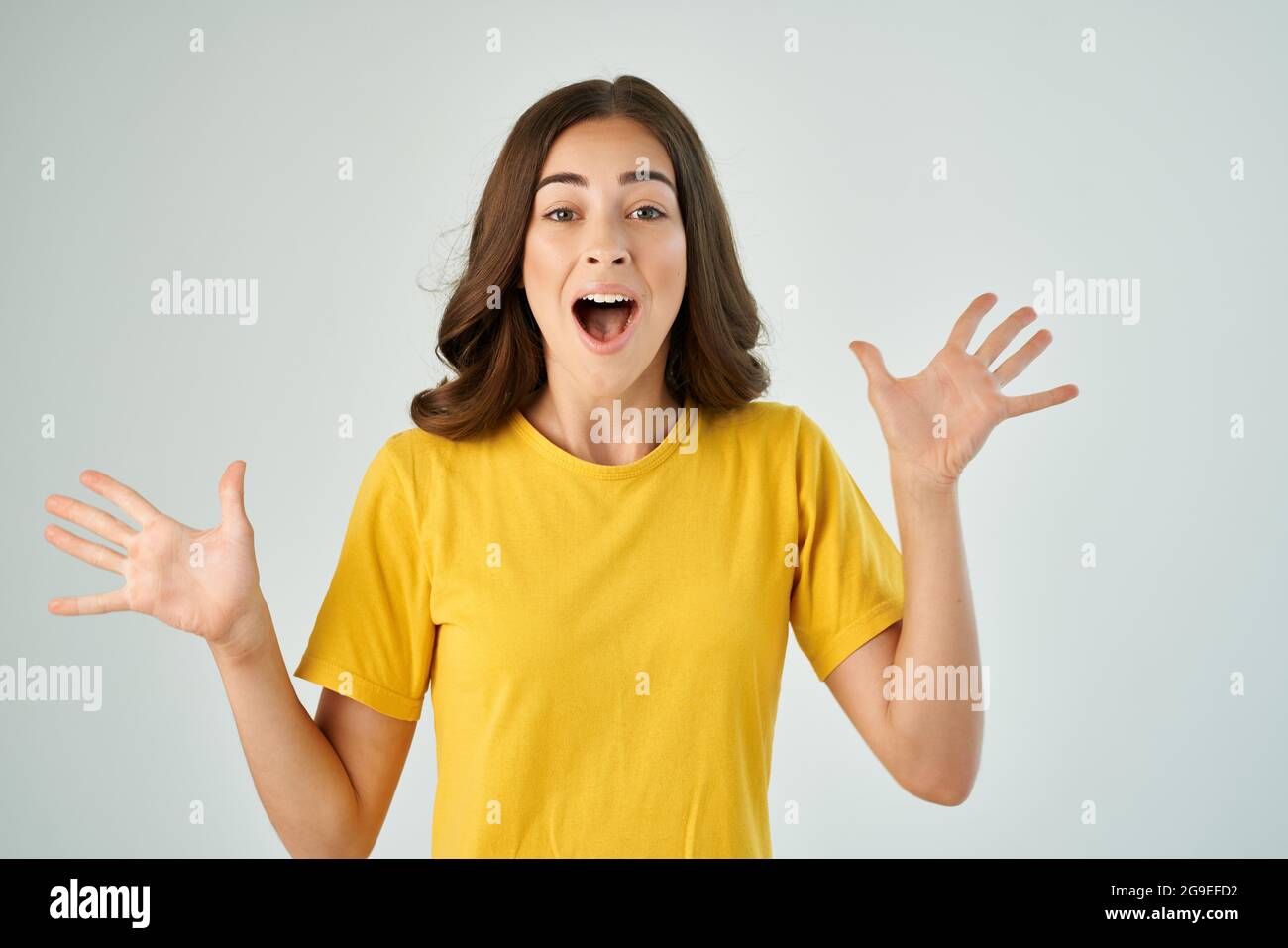 emotional brunette with open mouth screaming displeasure fear cropped ...