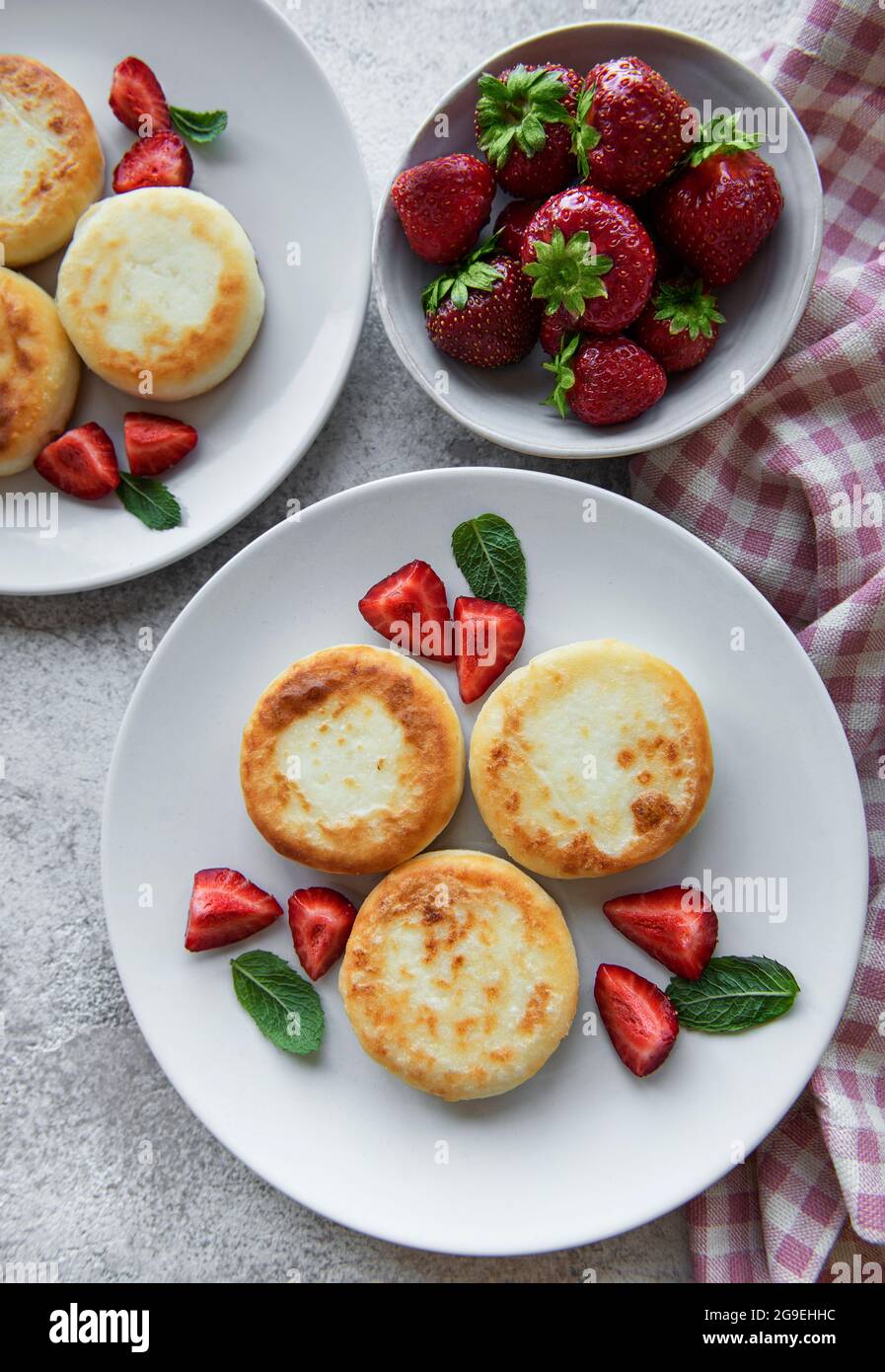 Cottage cheese pancakes, ricotta fritters on ceramic plate with fresh ...