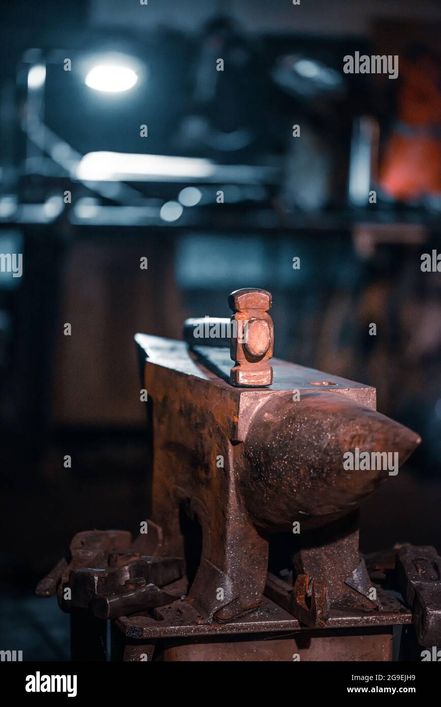 Large rusty anvil and hammer in the forge Stock Photo - Alamy