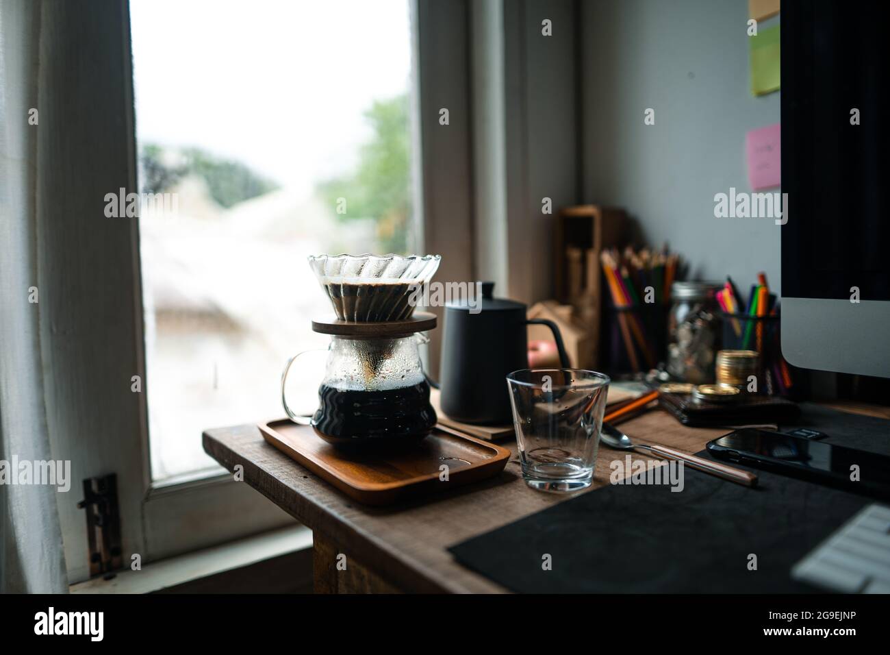 hot water into coffee dripper above glass jar Stock Photo - Alamy