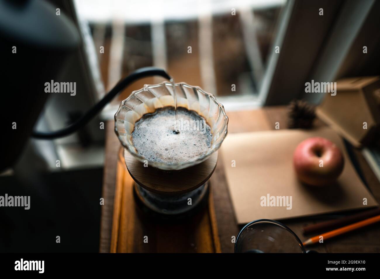 hot water into coffee dripper above glass jar Stock Photo - Alamy