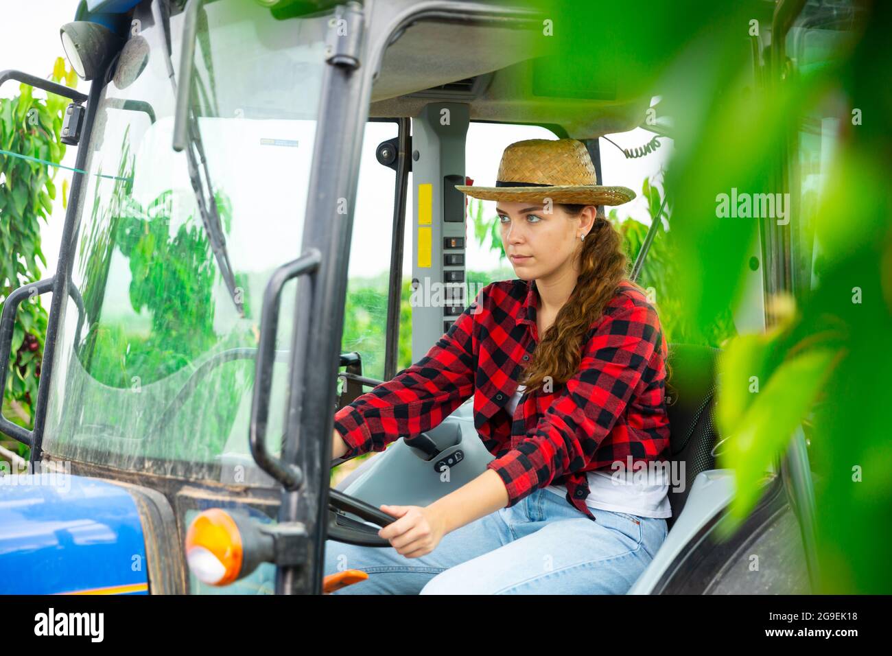 Portrait of female worker working on tractor Stock Photo - Alamy