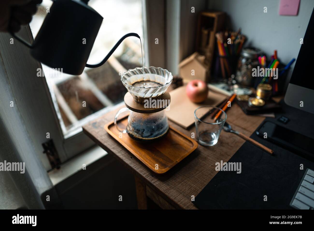 hot water into coffee dripper above glass jar Stock Photo - Alamy