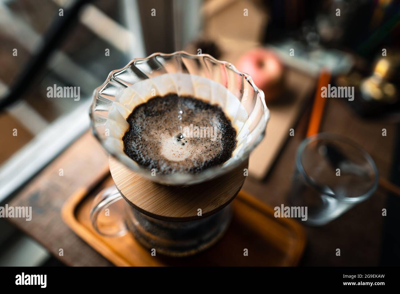 hot water into coffee dripper above glass jar Stock Photo - Alamy