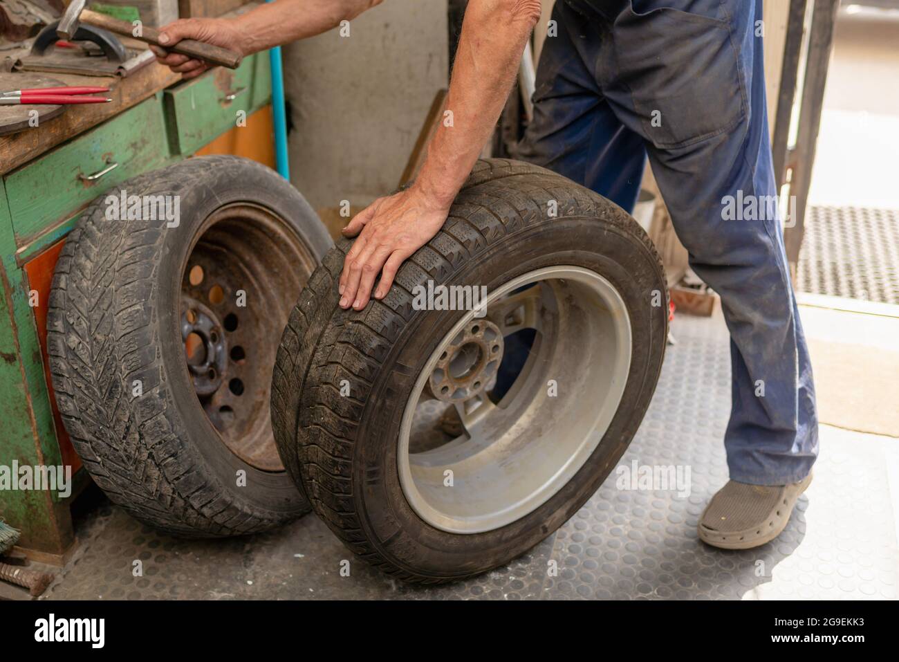 Mechanic changing tire in car service. Tire rotation machine.Car ...