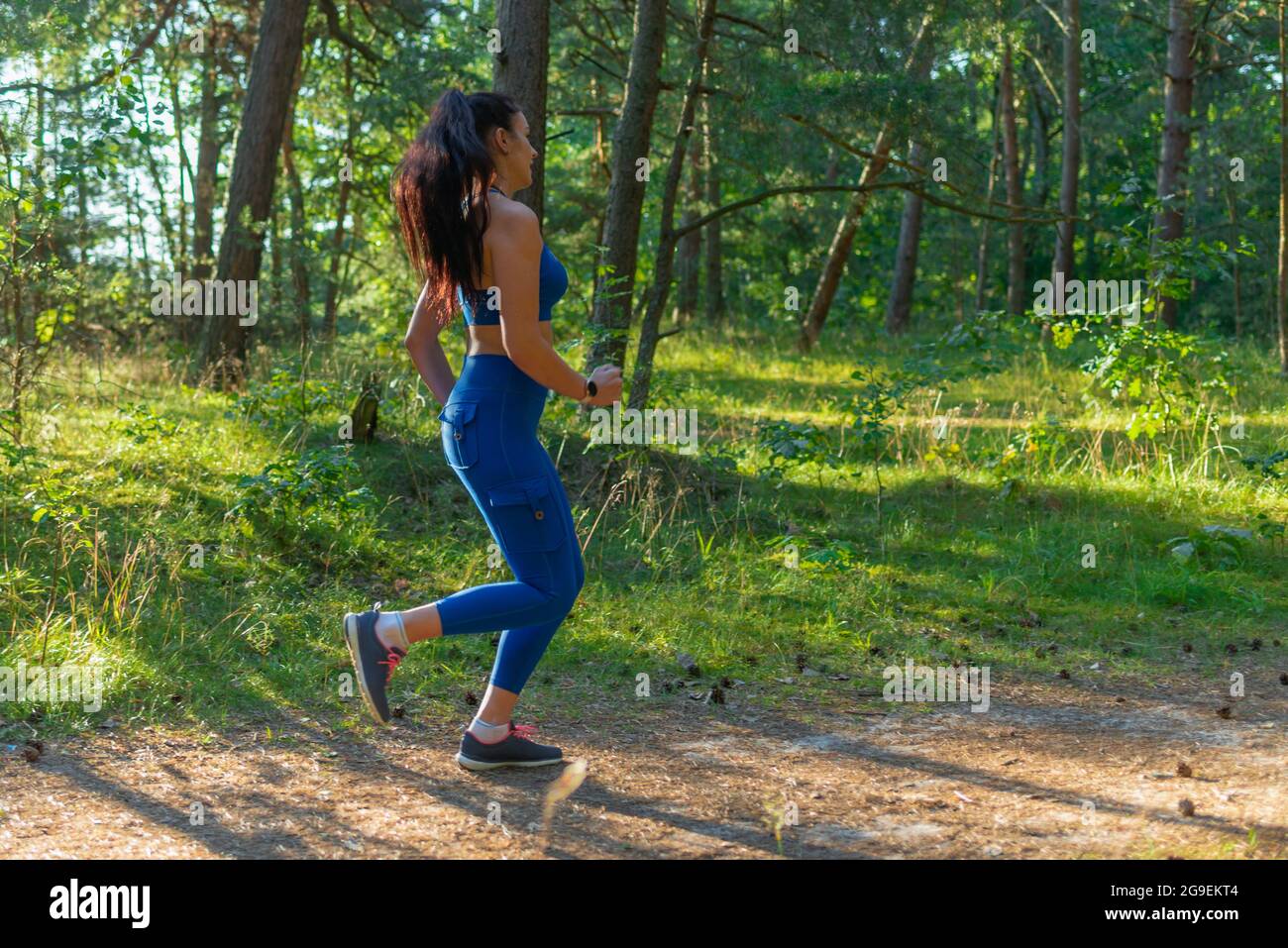 Pretty young girl runner jogging summer morning in the forest.Young ...