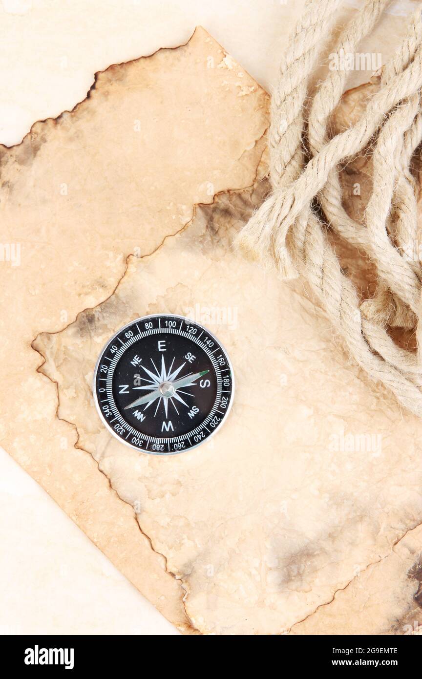 Old paper with compass and rope close up Stock Photo - Alamy