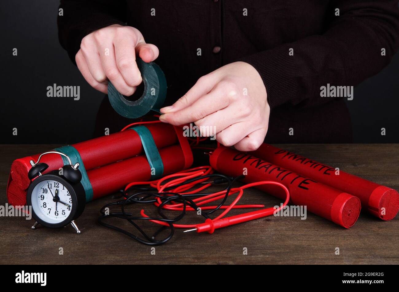 Human makes timebomb on wooden table on black background Stock Photo ...