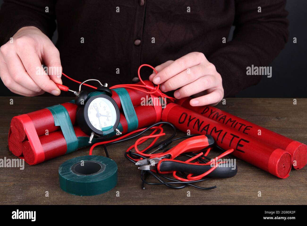 Human makes timebomb on wooden table on black background Stock Photo ...