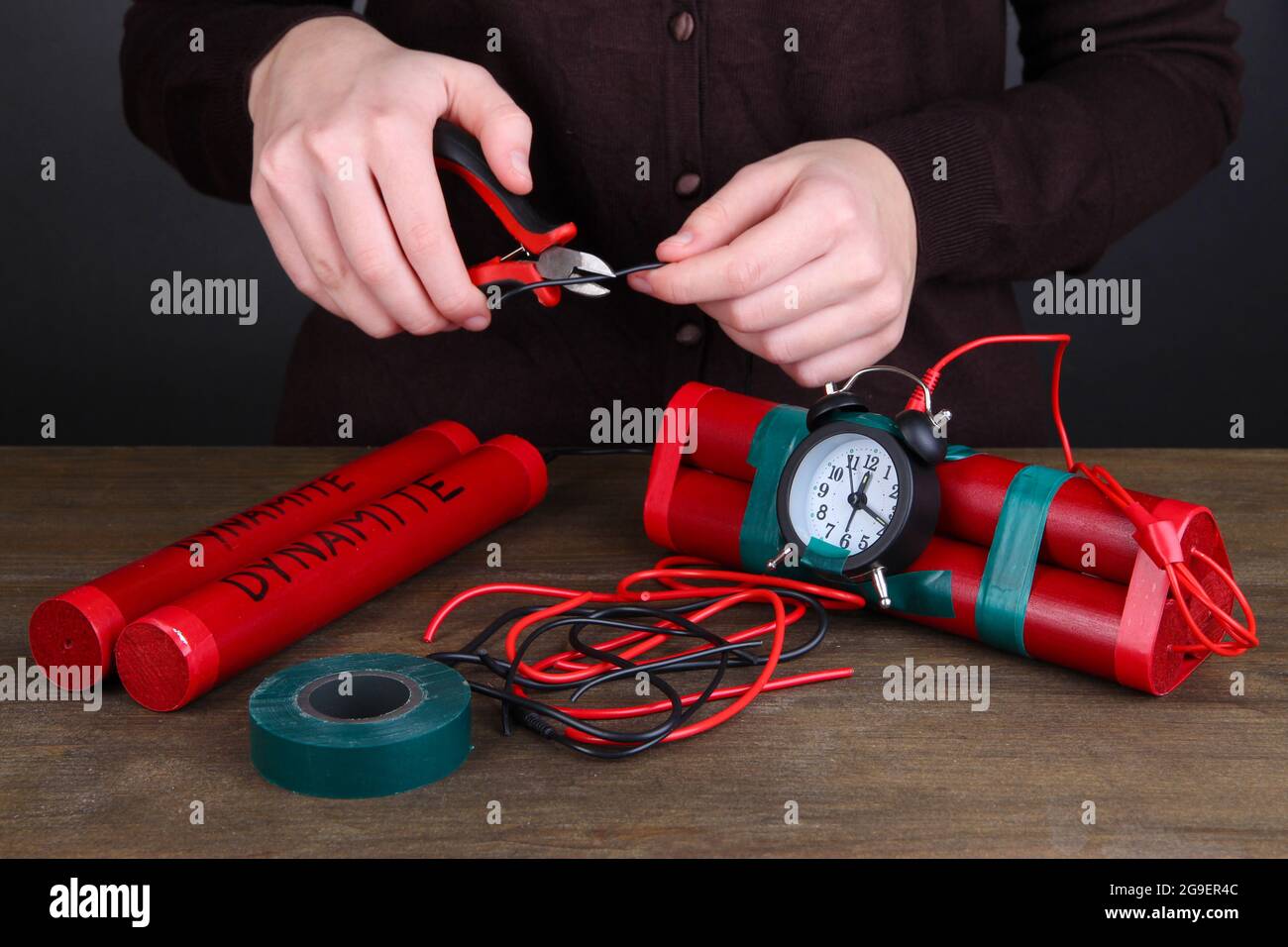 Human makes timebomb on wooden table on black background Stock Photo ...
