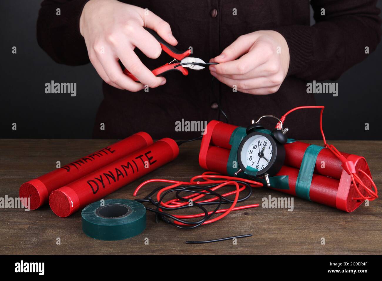 Human makes timebomb on wooden table on black background Stock Photo ...