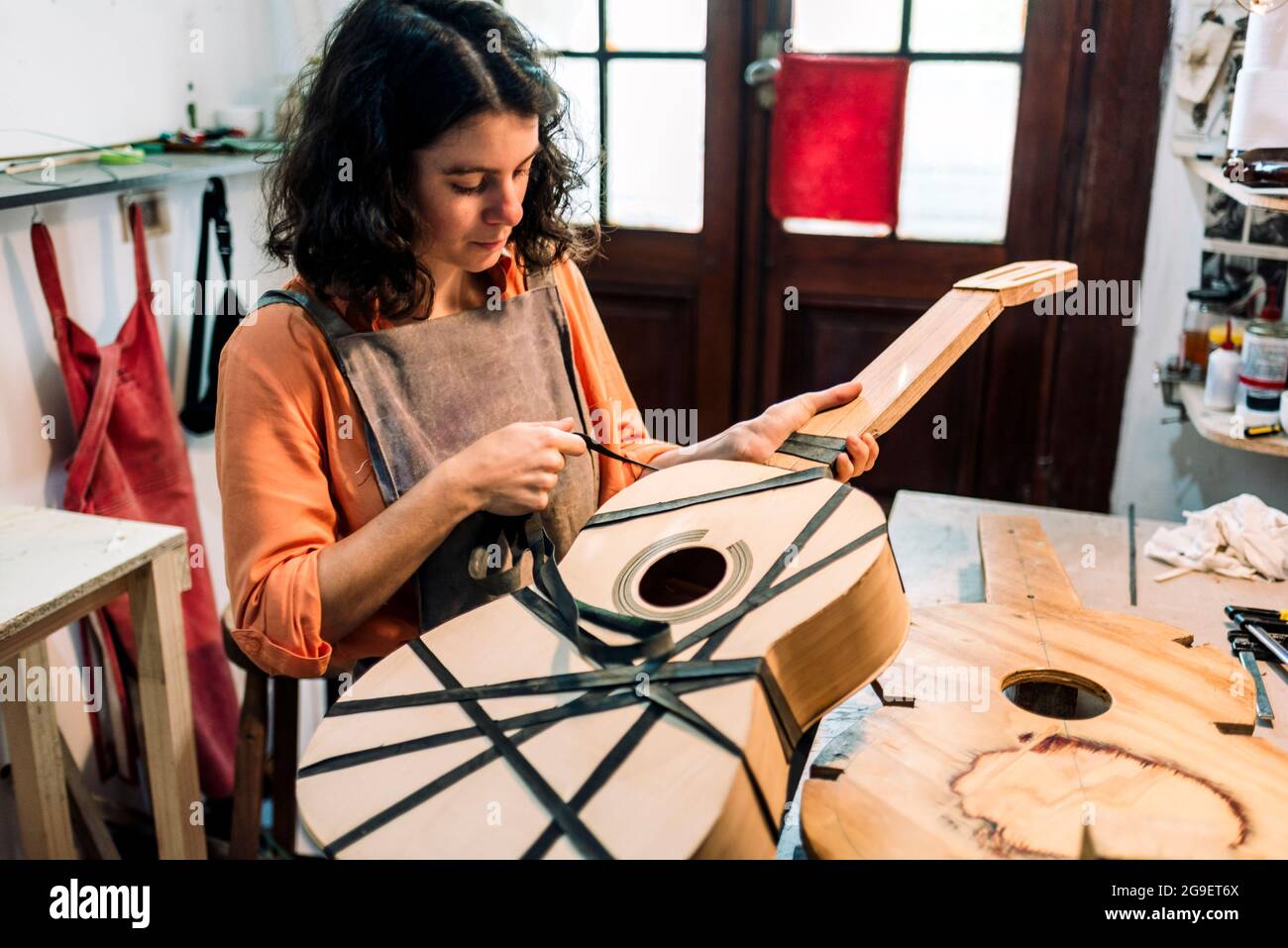 woman luthier making guitars in her musical instrument workshop Stock ...