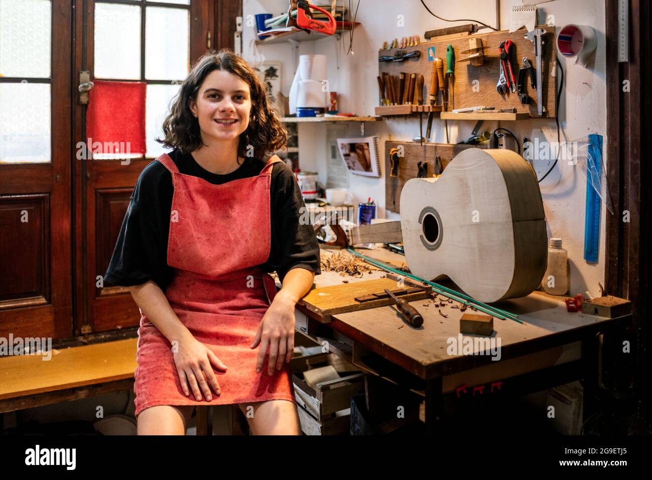 woman luthier making guitars in her musical instrument workshop Stock ...