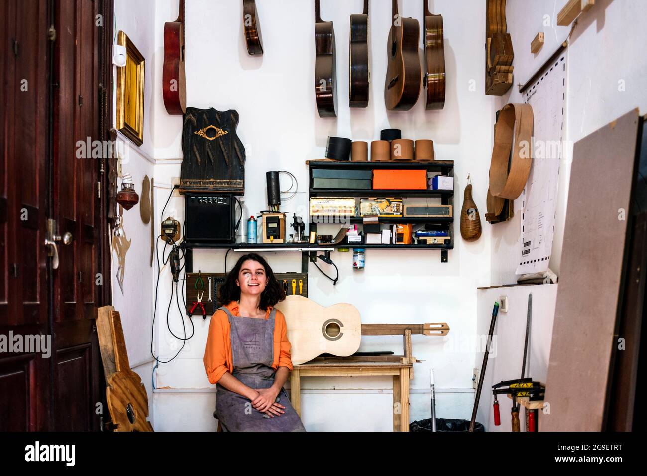 woman luthier making guitars in her musical instrument workshop Stock ...