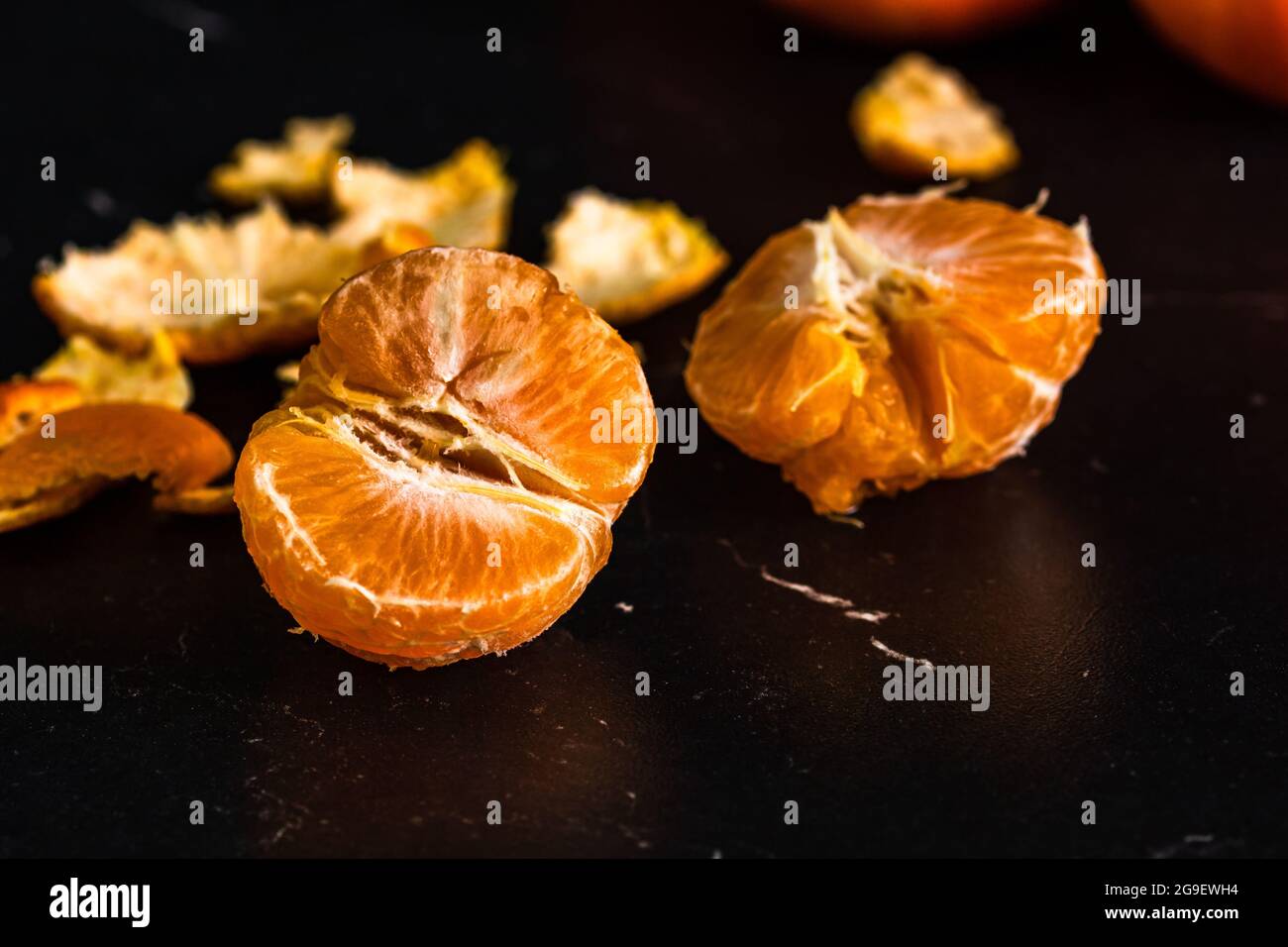 High angle shot of freshly sliced oranges on an isolated black ...