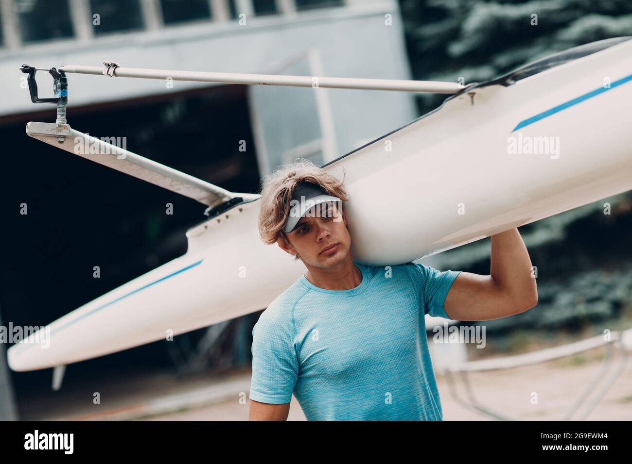 Sportsman single scull man rower carrying boat to competition Stock ...