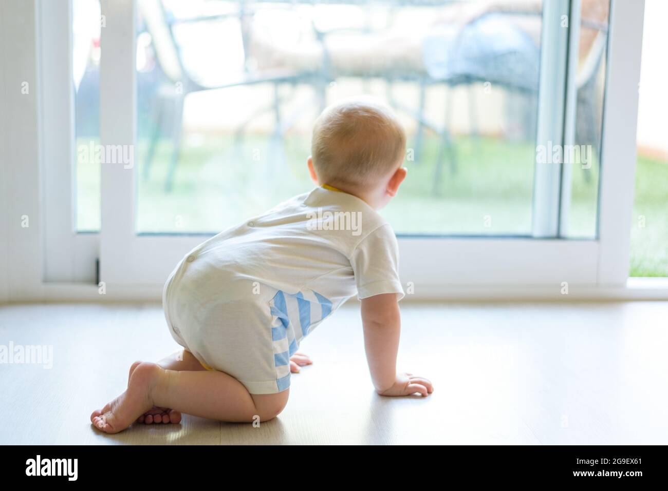 baby on his back crawling in the living room Stock Photo - Alamy