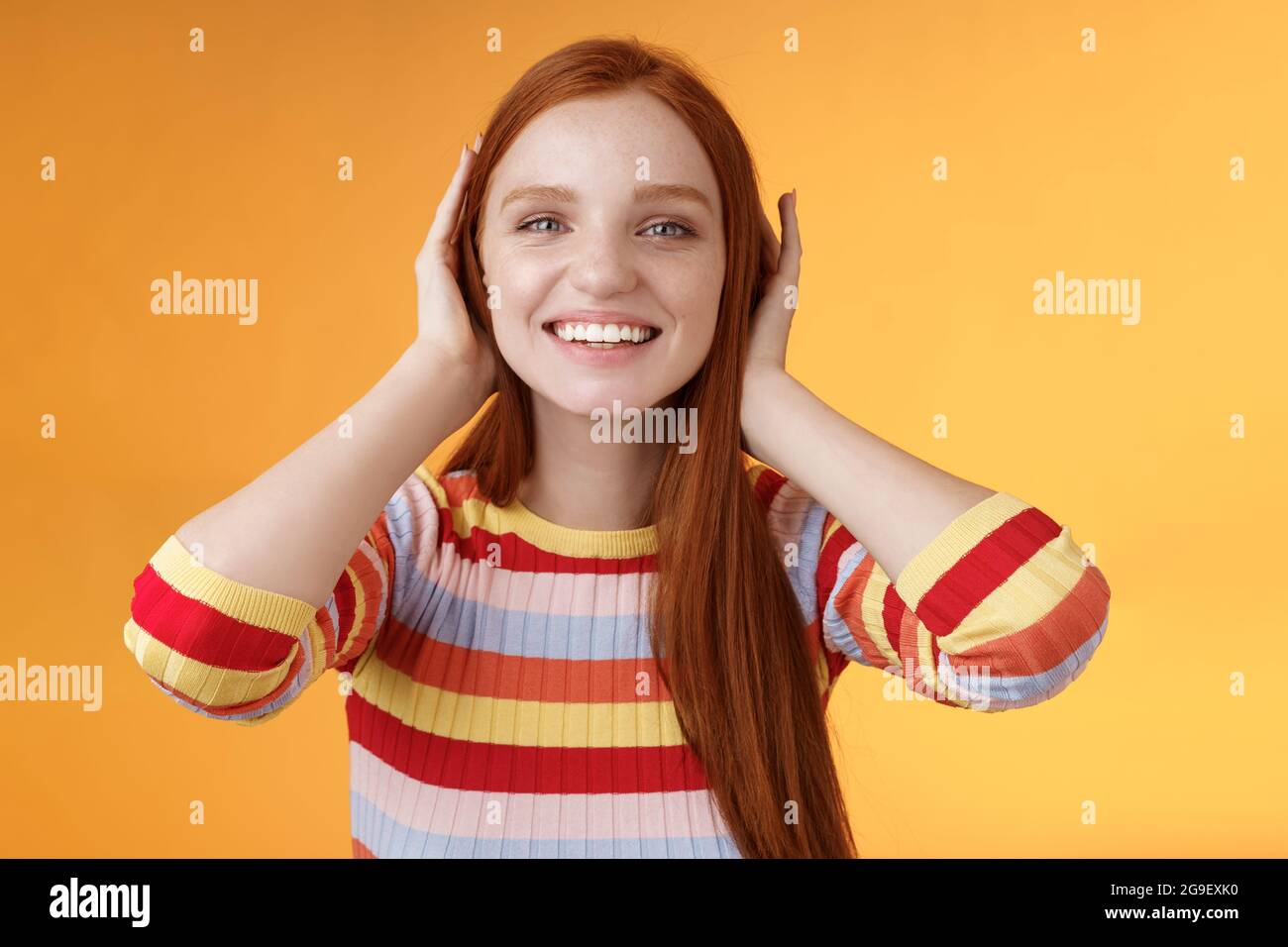 Cute playful tender smiling ginger girl blue eyes silly cover ears ...