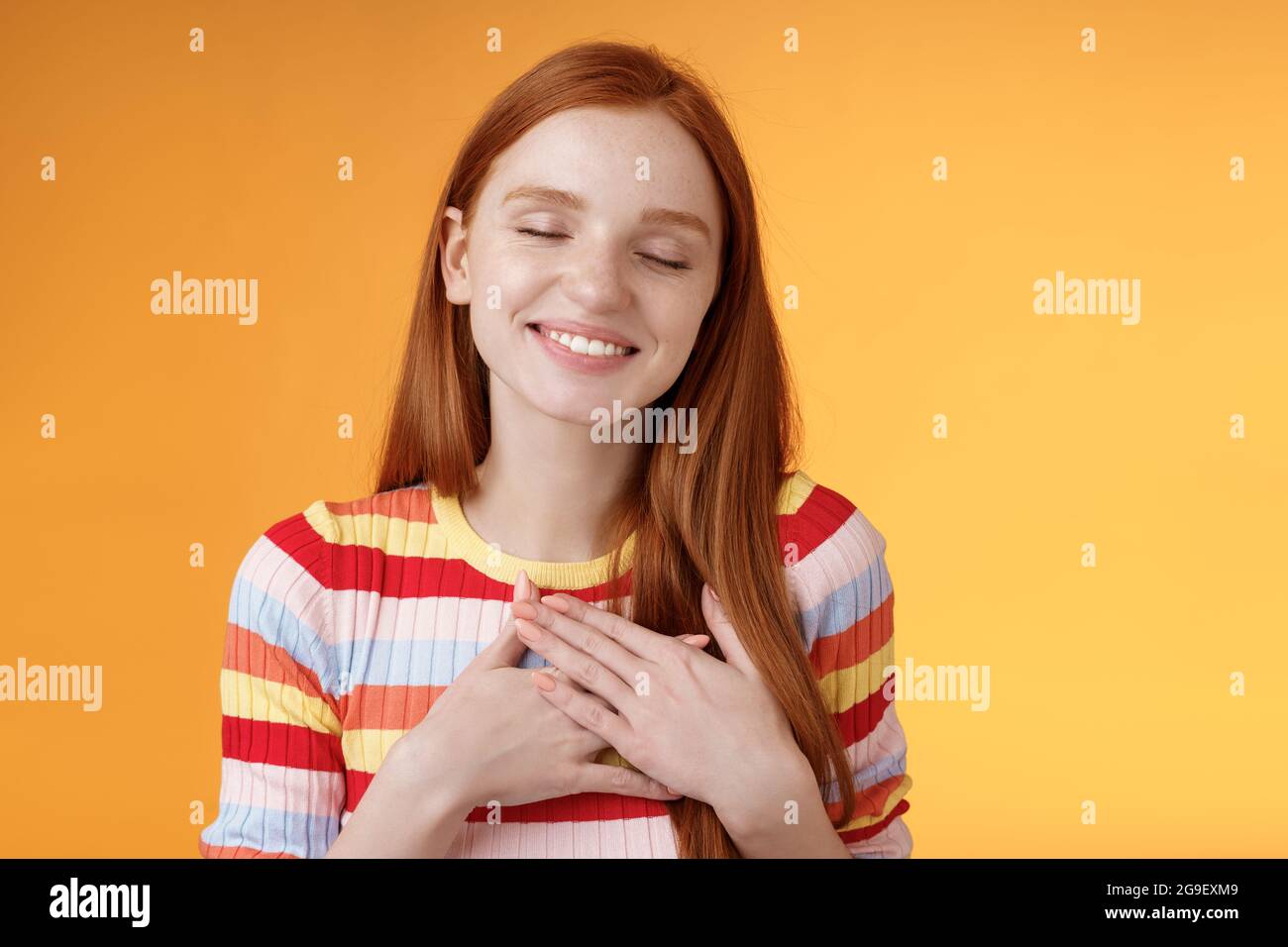 Happy Romantic Delighted Sighing Young Lovely Redhead Girlfriend Smiling Broadly Touching Heart