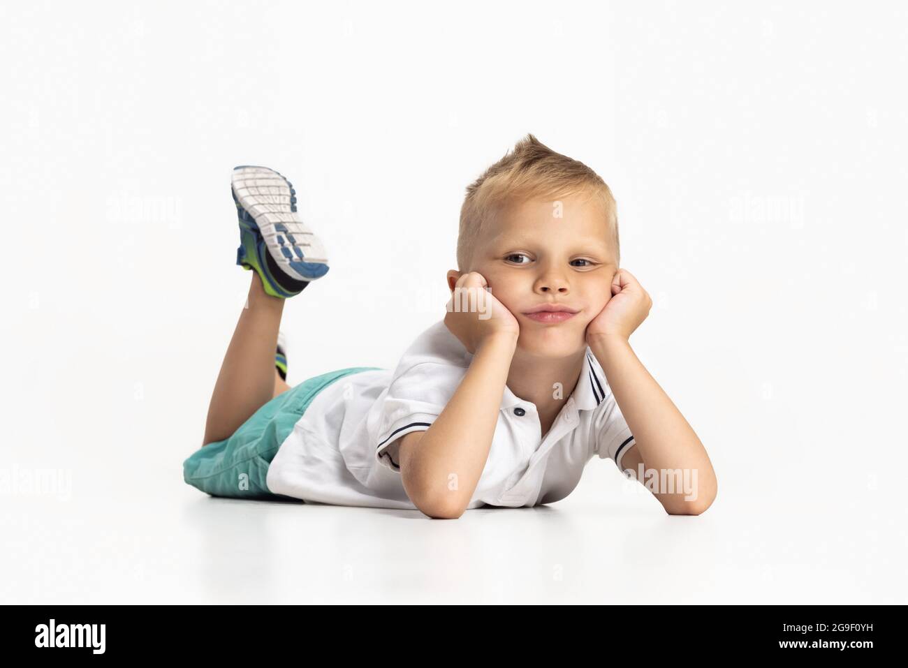 Portrait of cute preschool boy isolated on white studio background ...