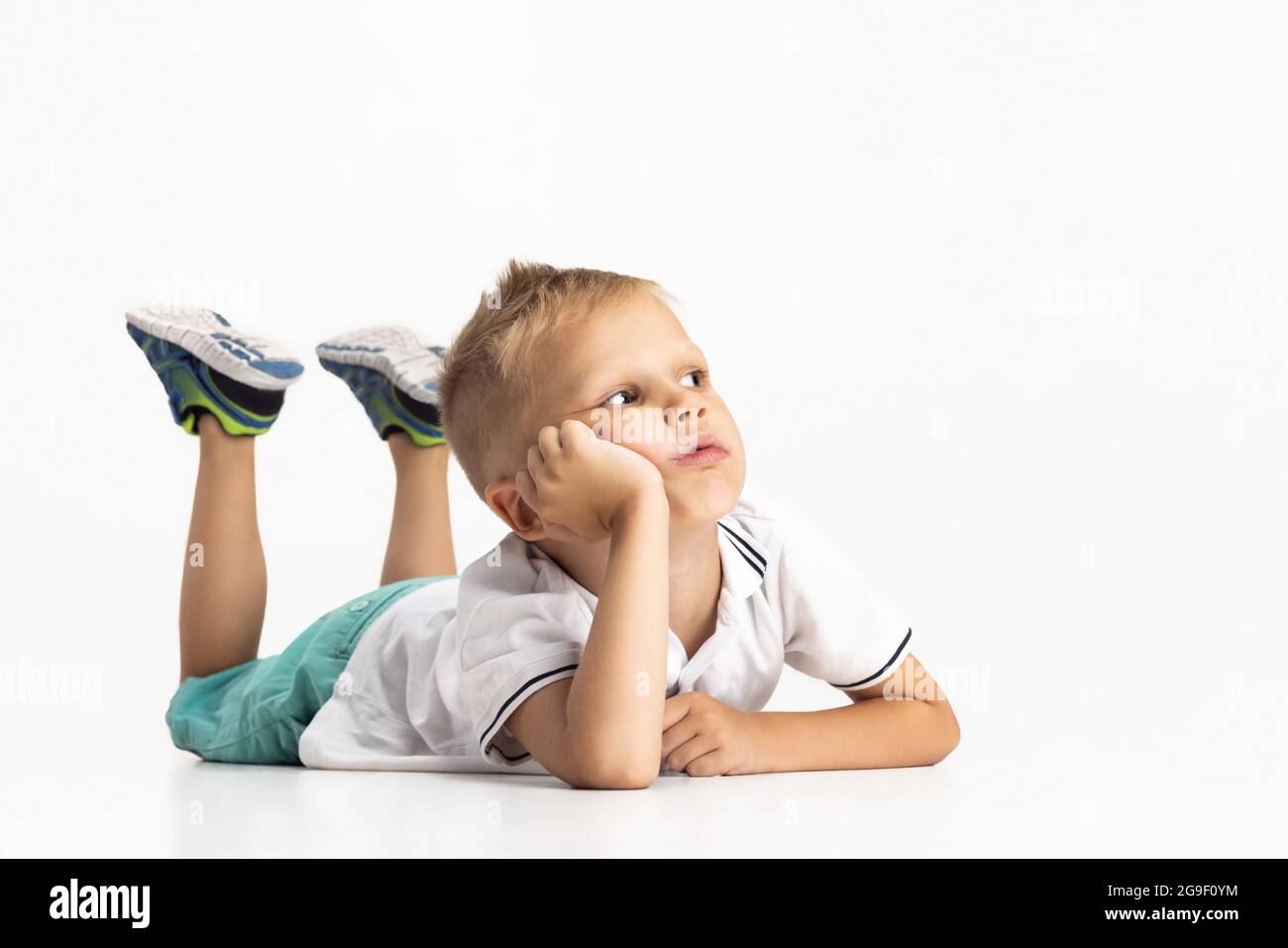 Portrait of cute preschool boy isolated on white studio background ...