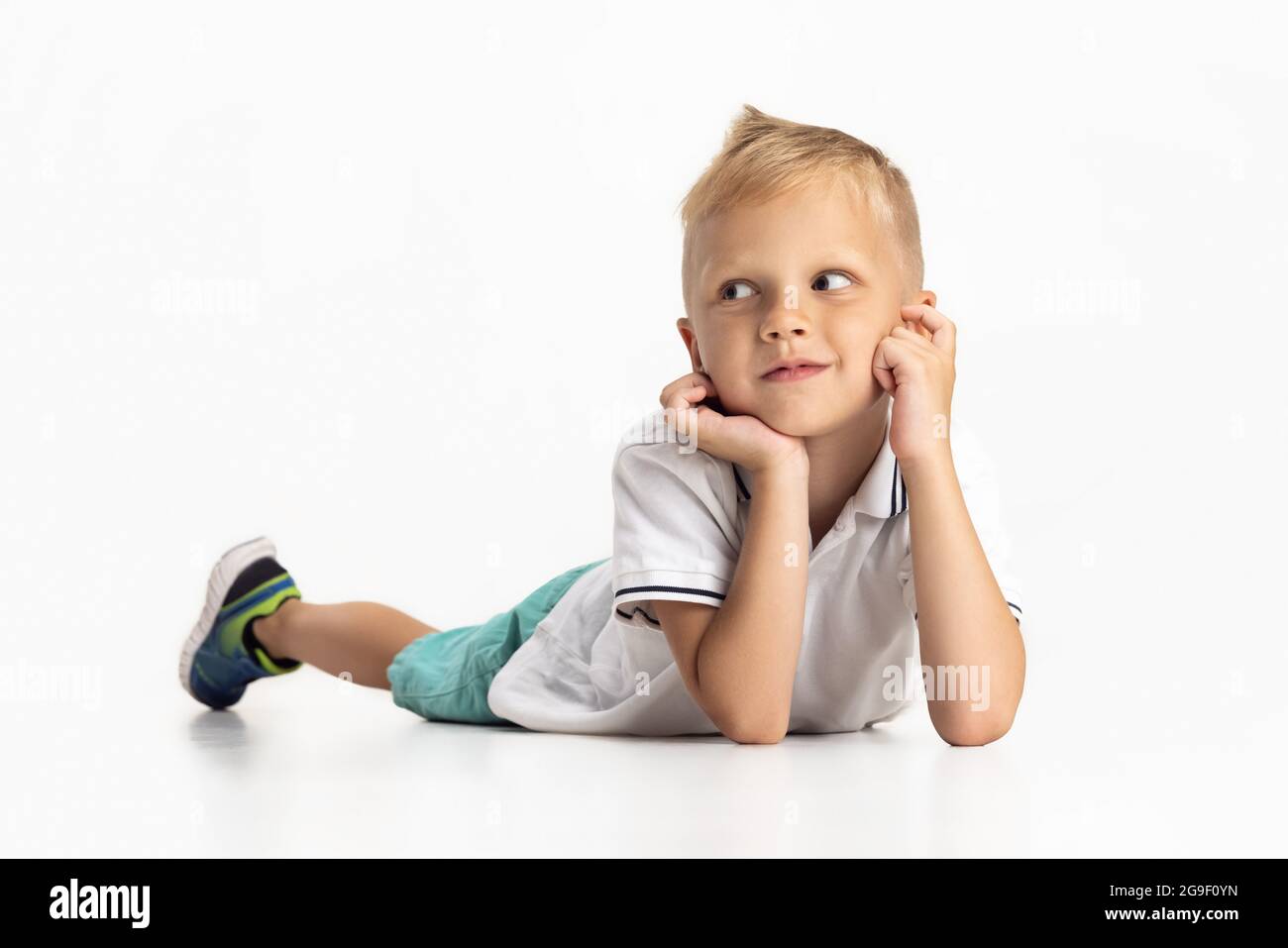 Portrait of cute preschool boy isolated on white studio background ...
