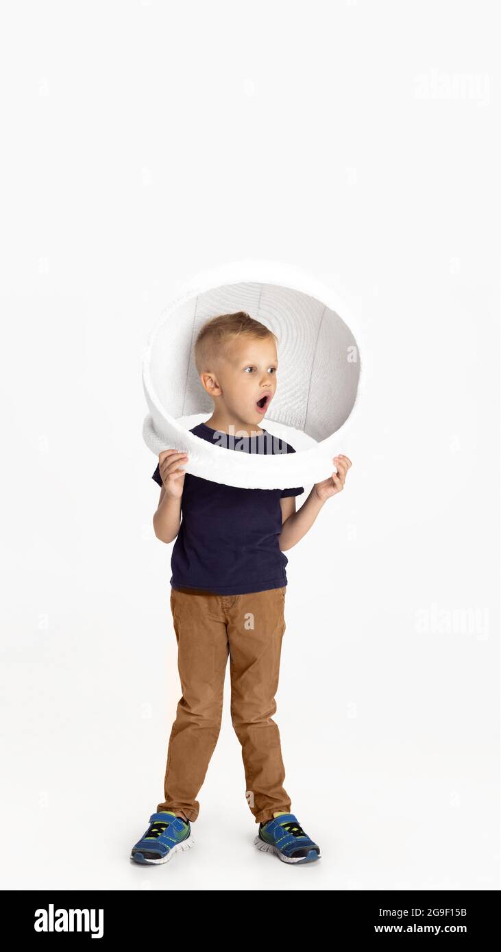 One preschool boy standing isolated on white studio background ...